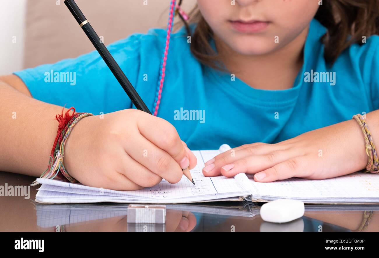 Little girl doing math homework with an abacus. Back to school concept ...