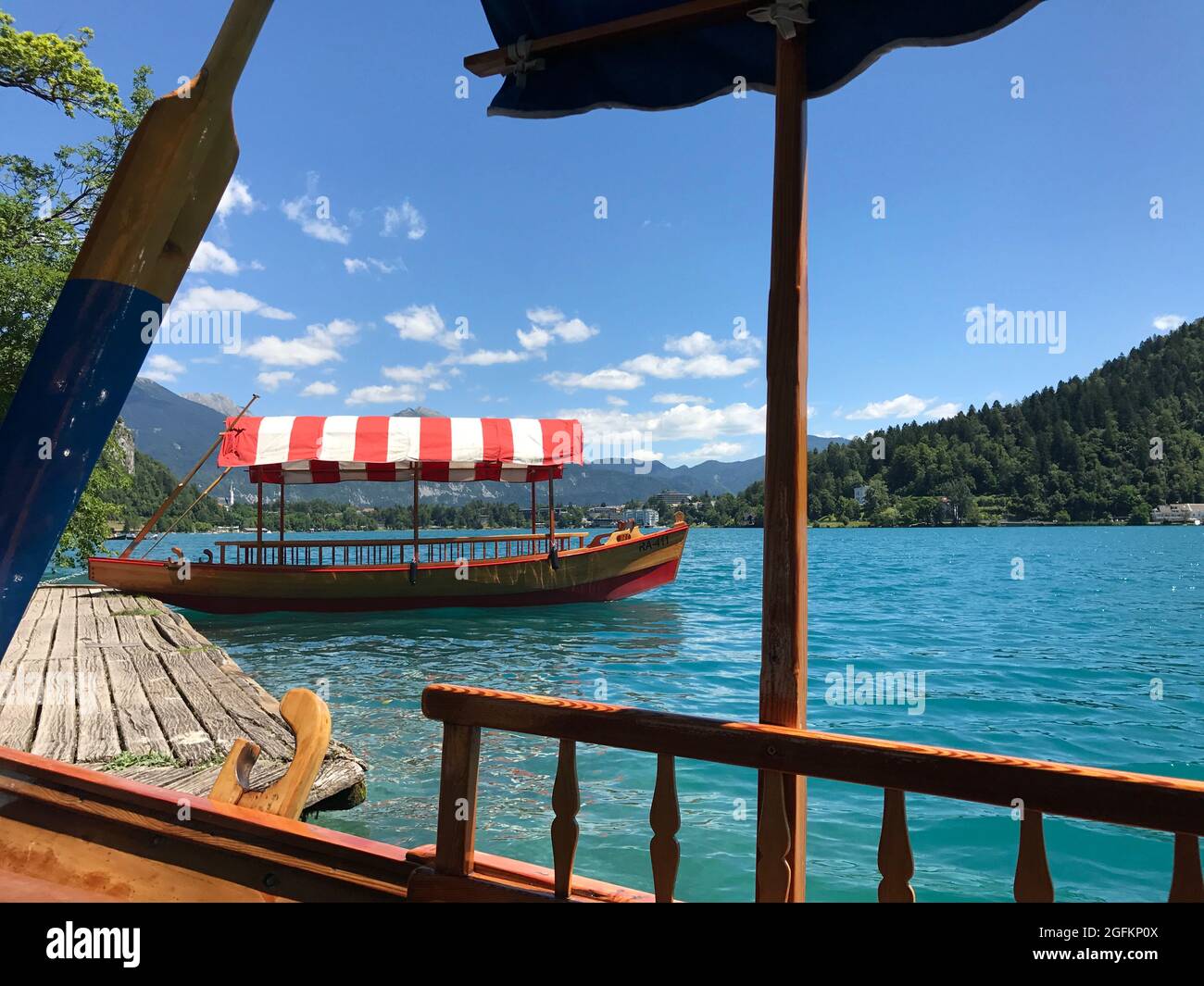 A Pletna boat on Lake Bled and Bled Castle, Gorenjska, Slovenia Stock ...