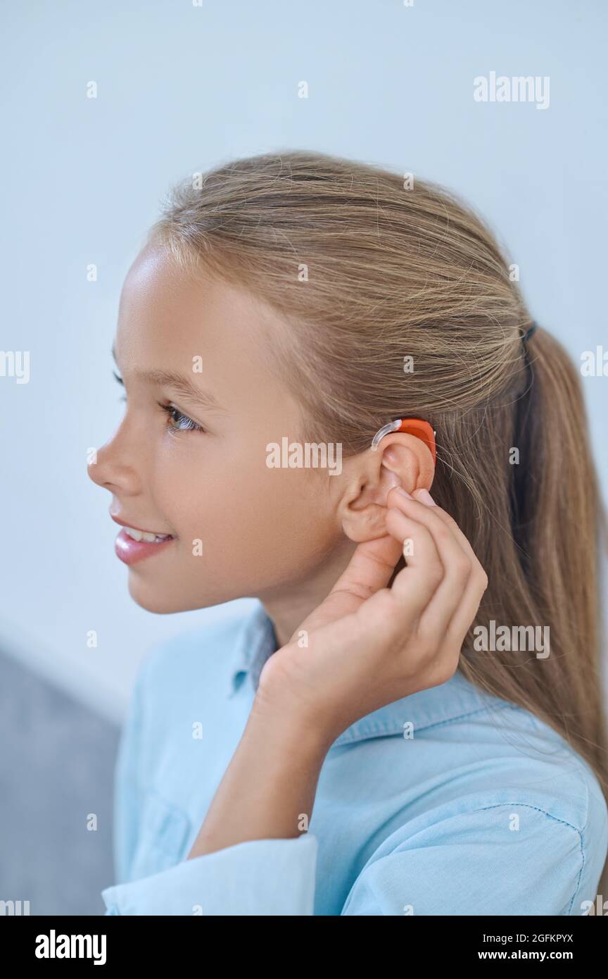 Girl with beautiful appearance in stylish hearing aid Stock Photo - Alamy
