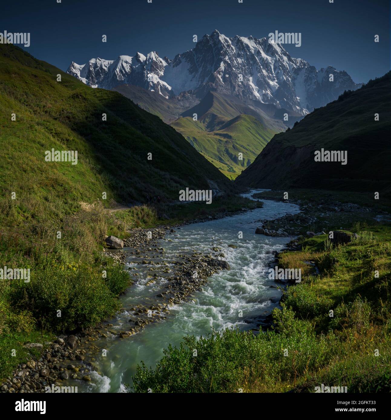 The epic snow-capped Bezengi Wall and valley of the Caucasus in Ushguli ...