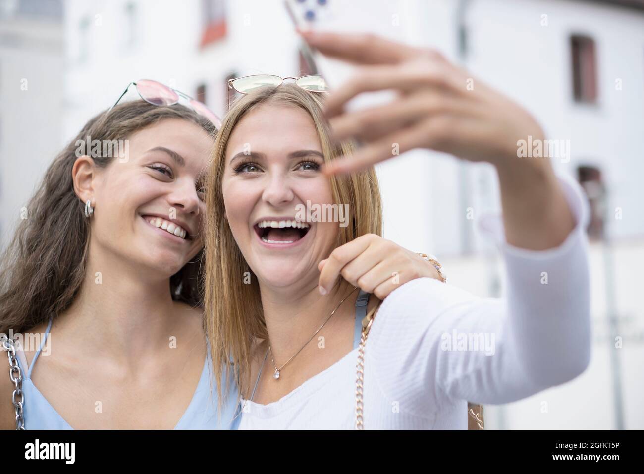 two young women making selfy with mobilephone in surroundings Stock ...