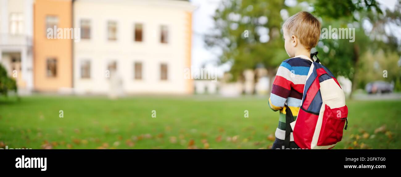 Cute child with backpack going to the school Stock Photo - Alamy