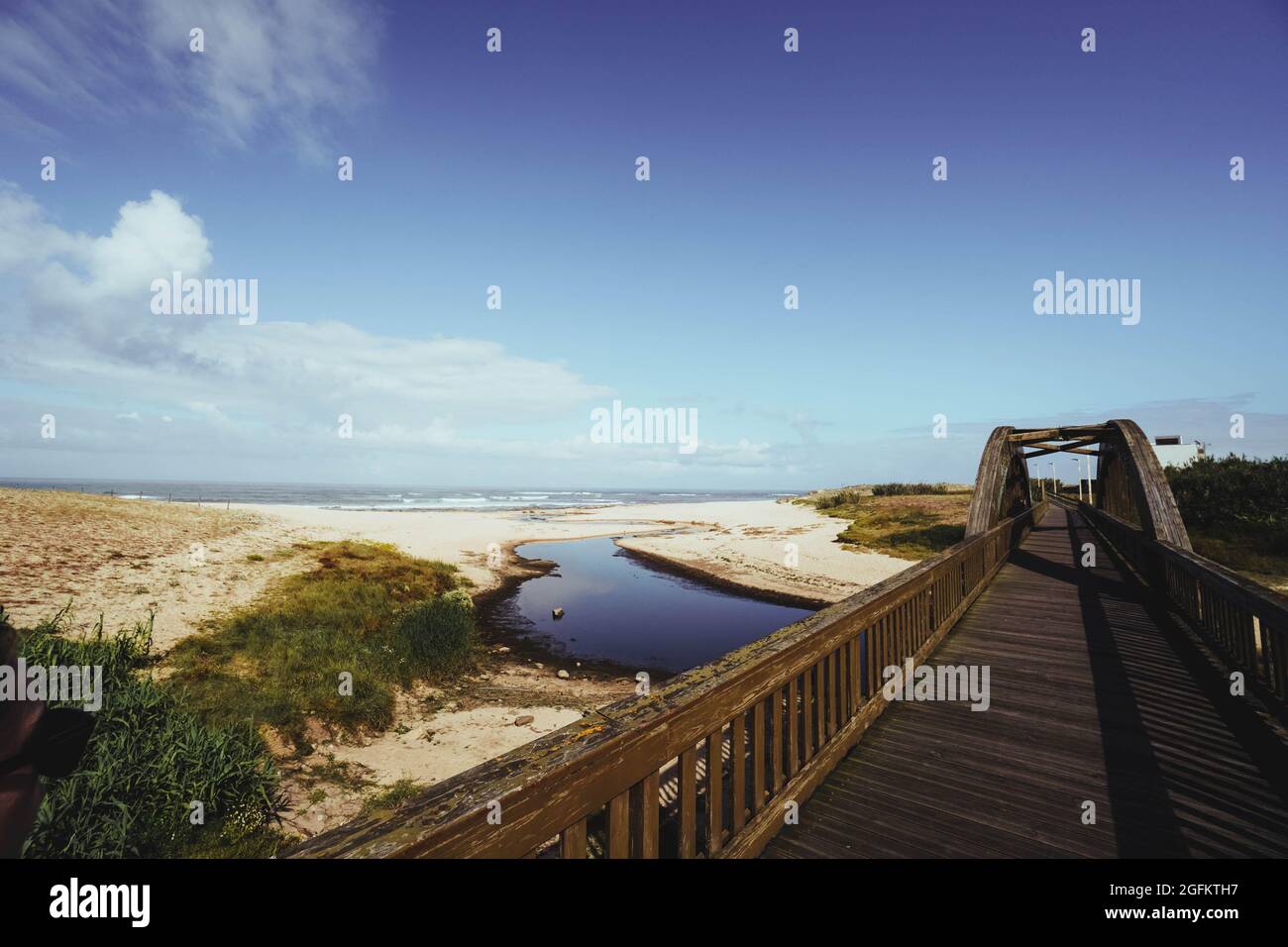 landscape of bridge crossing sandy beach near the sea Stock Photo - Alamy