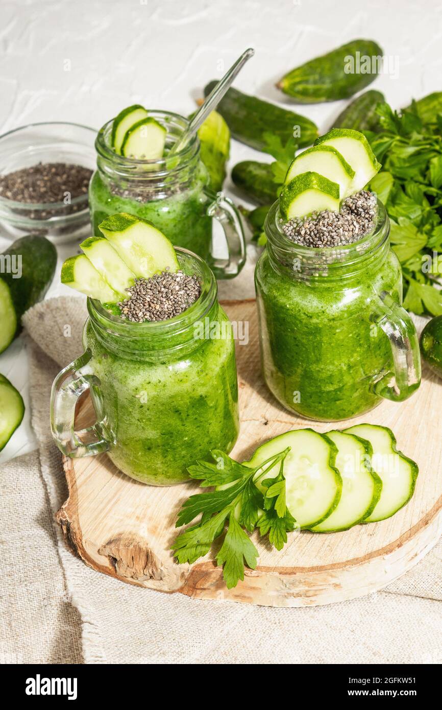 Green smoothie with cucumber in a glass jar. Fresh ripe vegetables ...