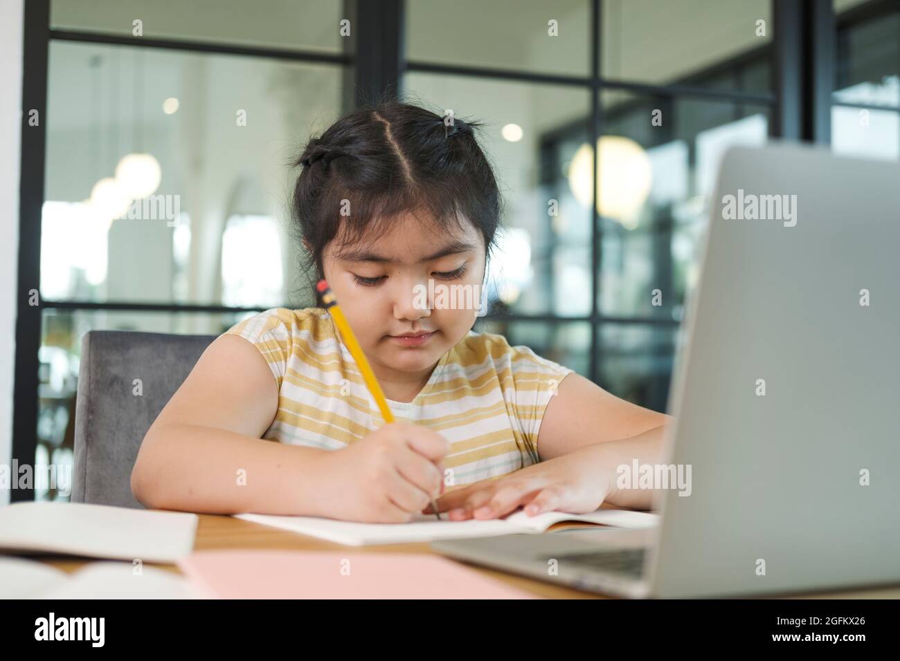 Cute and happy little girl children using laptop computer, studying ...