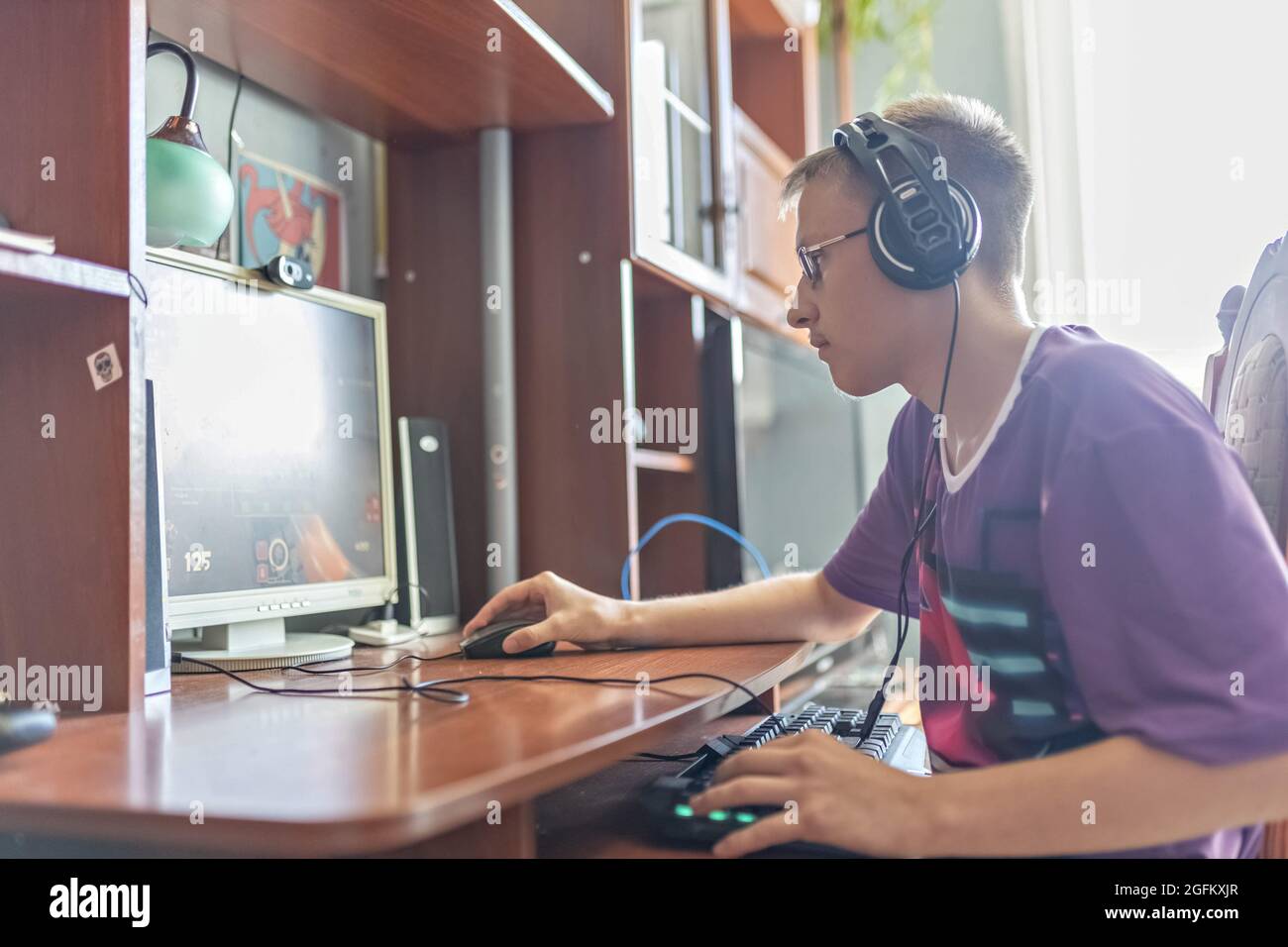 Boy using computer with headphones hi-res stock photography and images ...