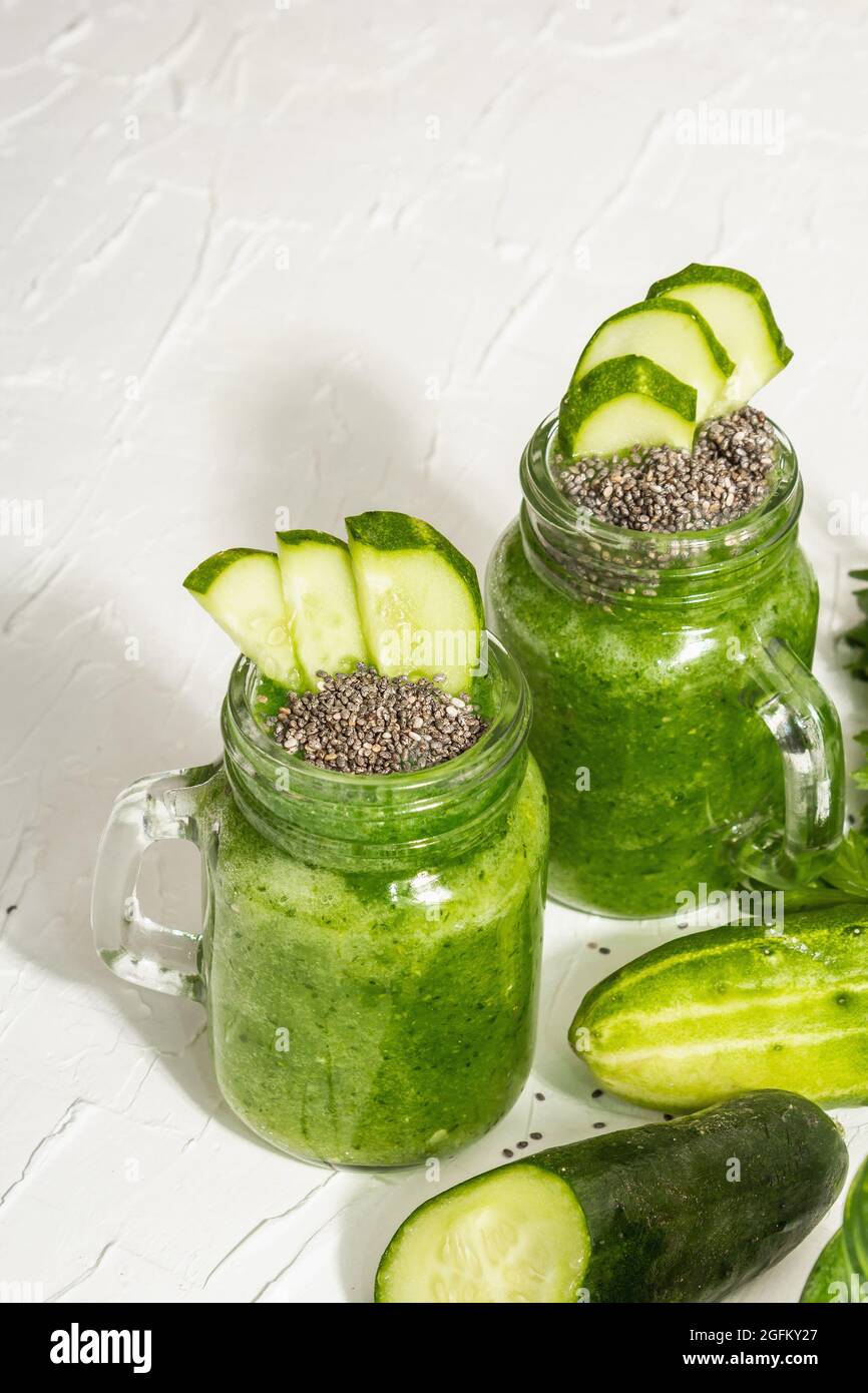Green smoothie with cucumber in a glass jar. Fresh ripe vegetables ...