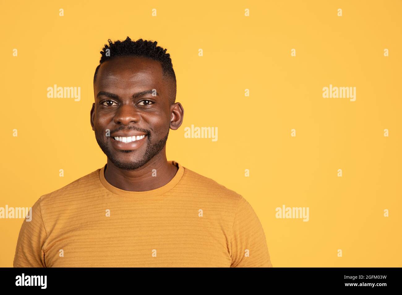 Portrait of African young man in casual clothes isolated on yellow ...