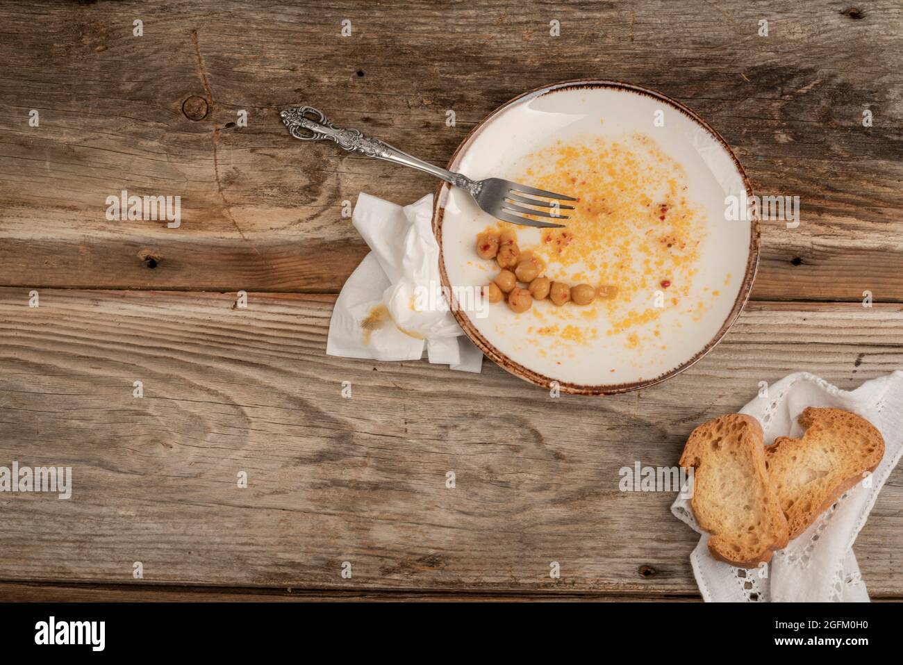 left overs and bread on wooden table after dinner Stock Photo - Alamy