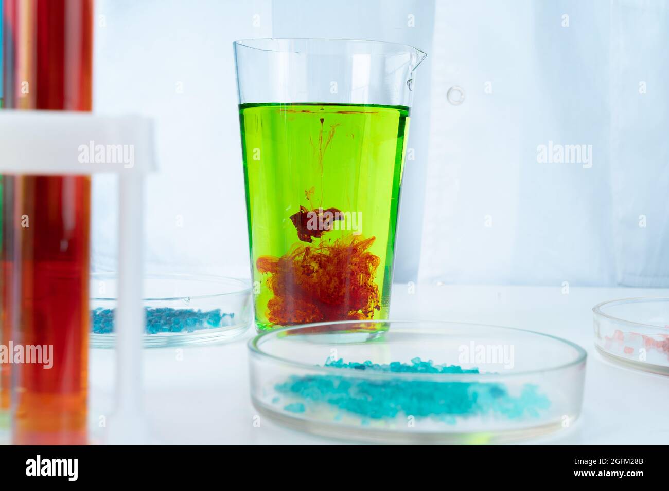 Manipulations with laboratory glass chemical containers on table Stock ...