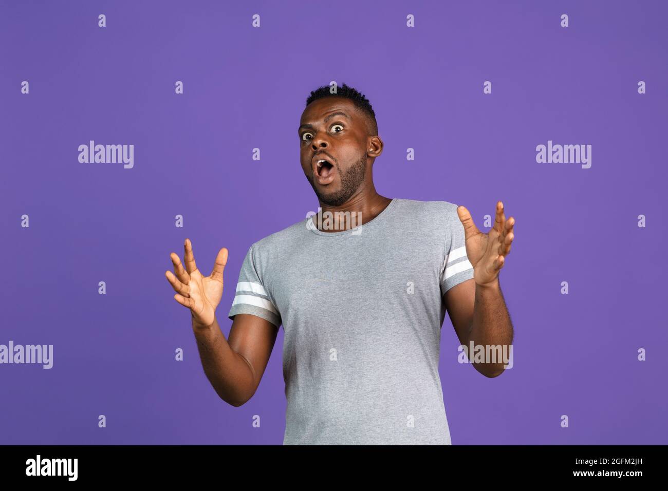 African-american young man's portrait on purple color studio background ...