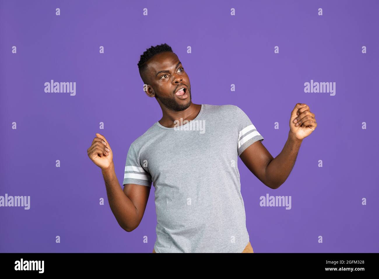 African-american young man's portrait on purple color studio background ...