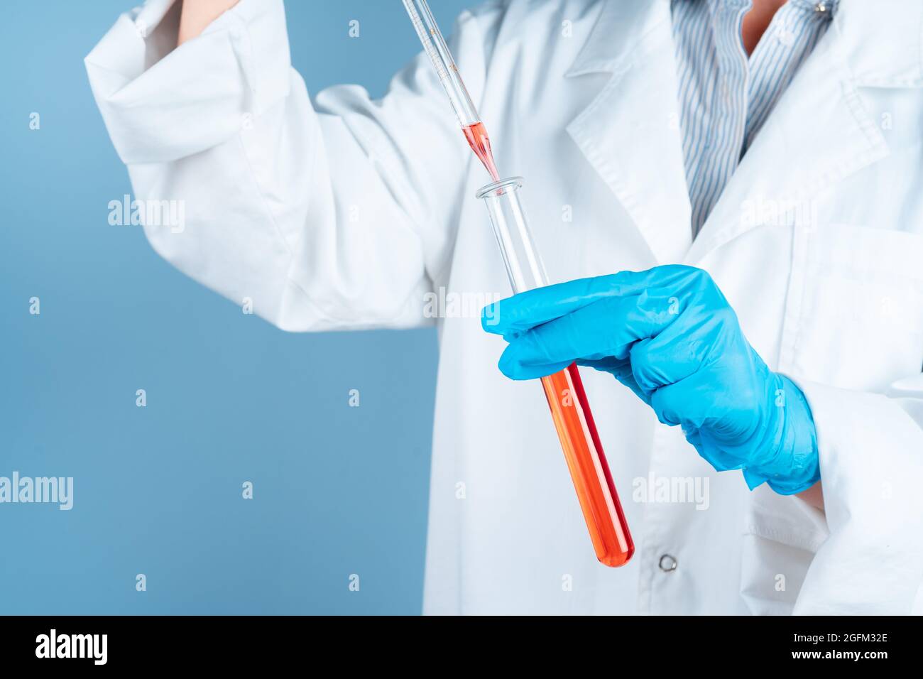 Young scientist with test tube making research in clinical laboratory ...