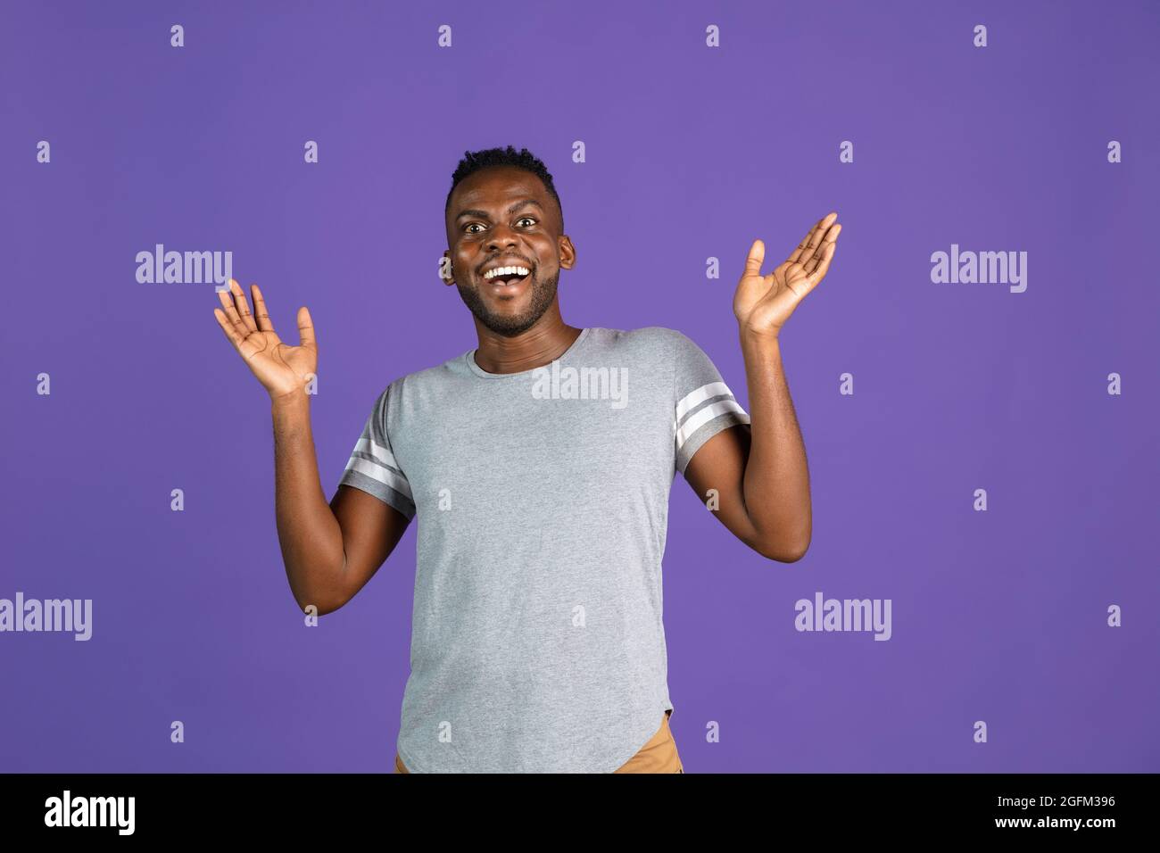 African-american young man's portrait on purple color studio background ...