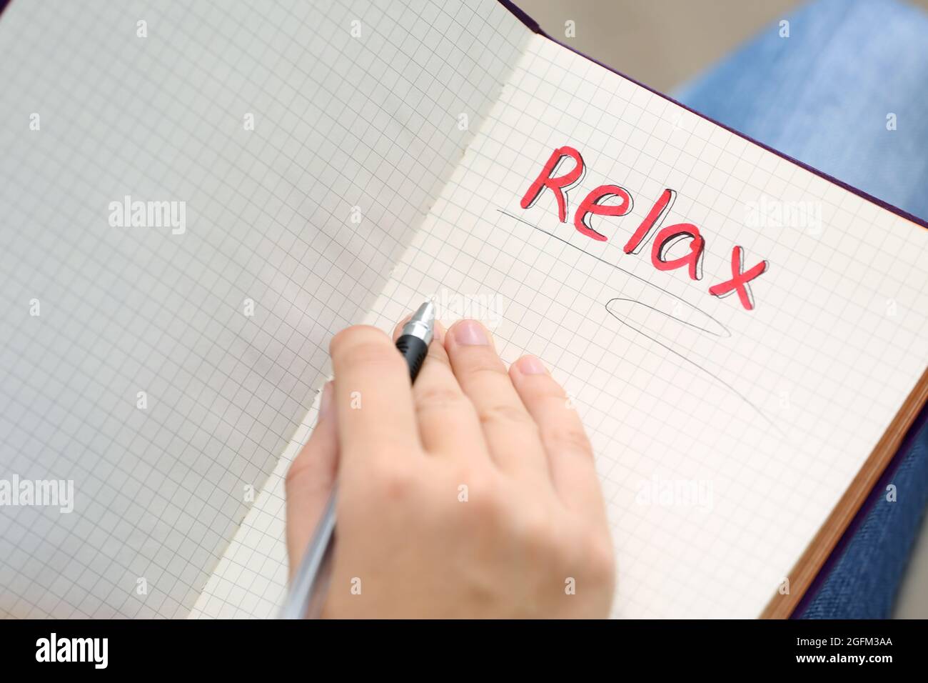 Young woman writing word "relax" in notebook, close up view Stock Photo ...