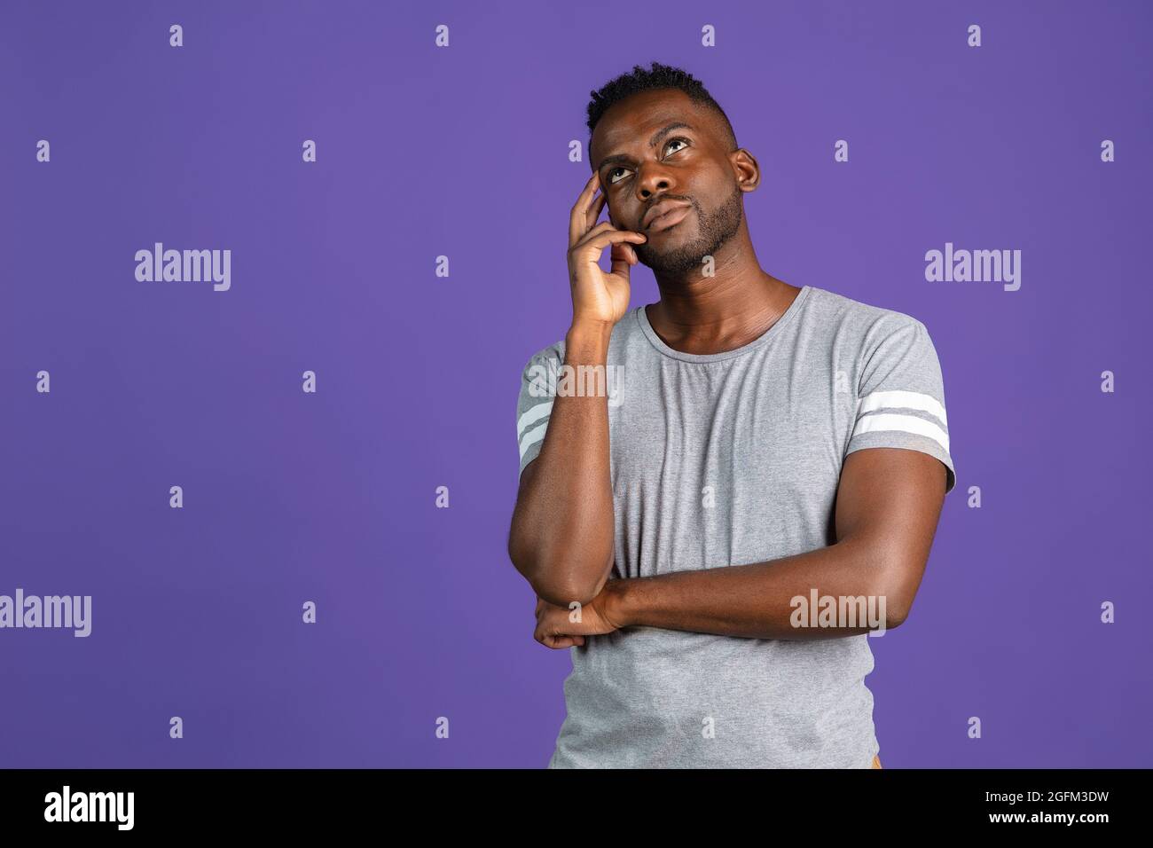 One African-american young man isolated on purple color studio ...