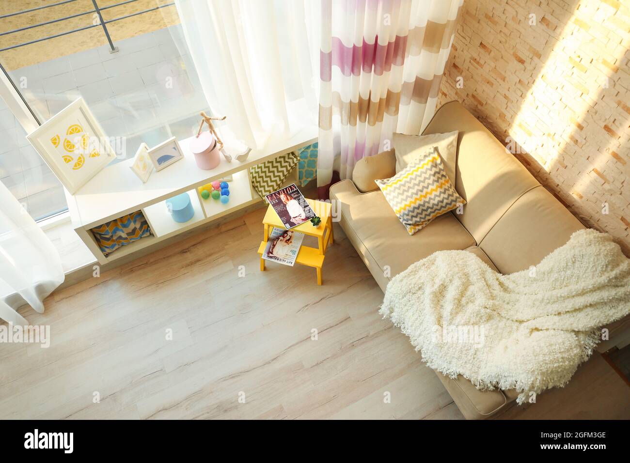Modern interior with sofa, window and small chair Stock Photo - Alamy