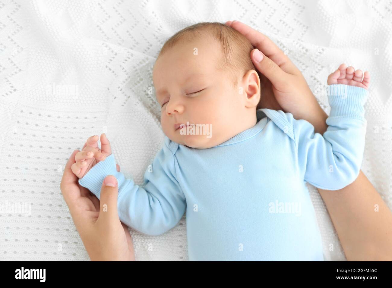Mother hands touching cute sleeping baby, close up view Stock Photo - Alamy