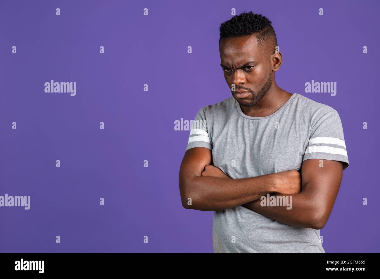 African-american young man's portrait on purple color studio background ...