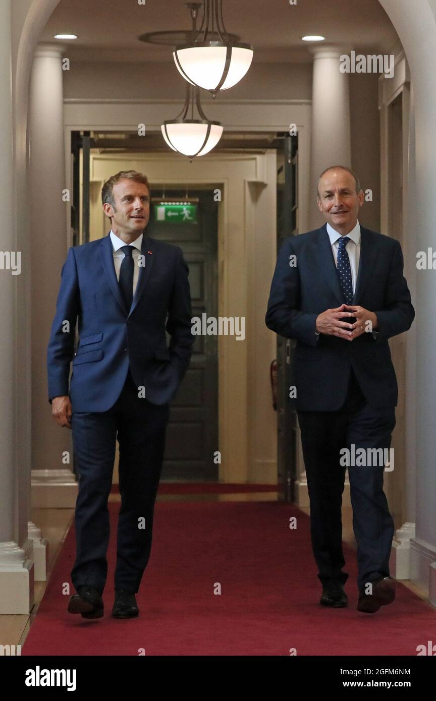 Taoiseach Micheal Martin (right) walks with French President Emmanuel ...