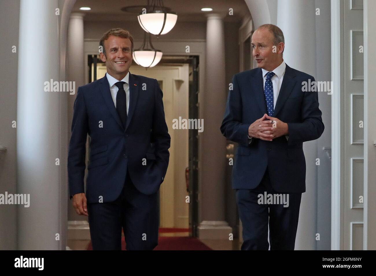 Taoiseach Micheal Martin (right) walks with French President Emmanuel ...