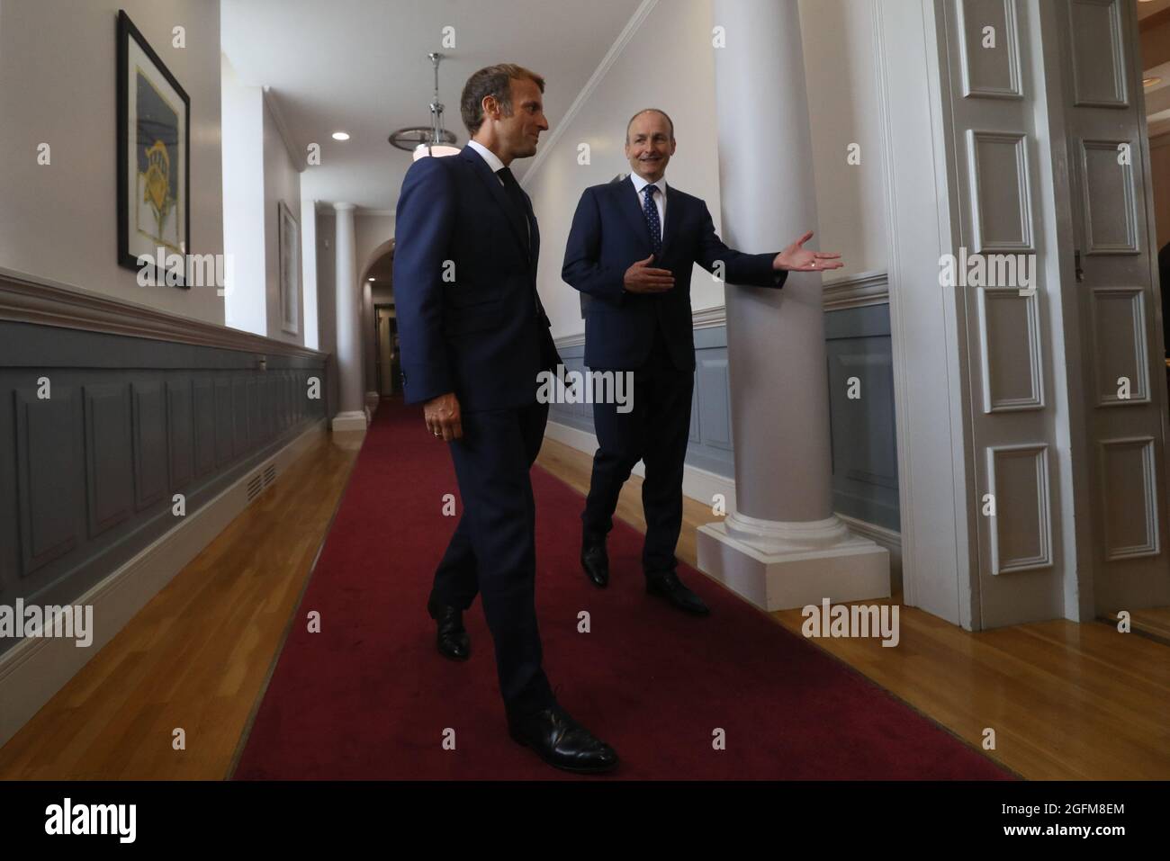 Taoiseach Micheal Martin (right) walks with French President Emmanuel ...