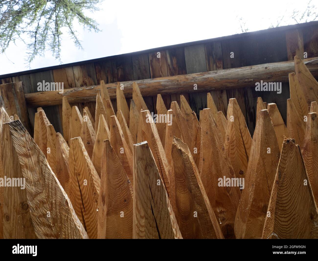 Pointed wood logs pattern inside hut Stock Photo - Alamy