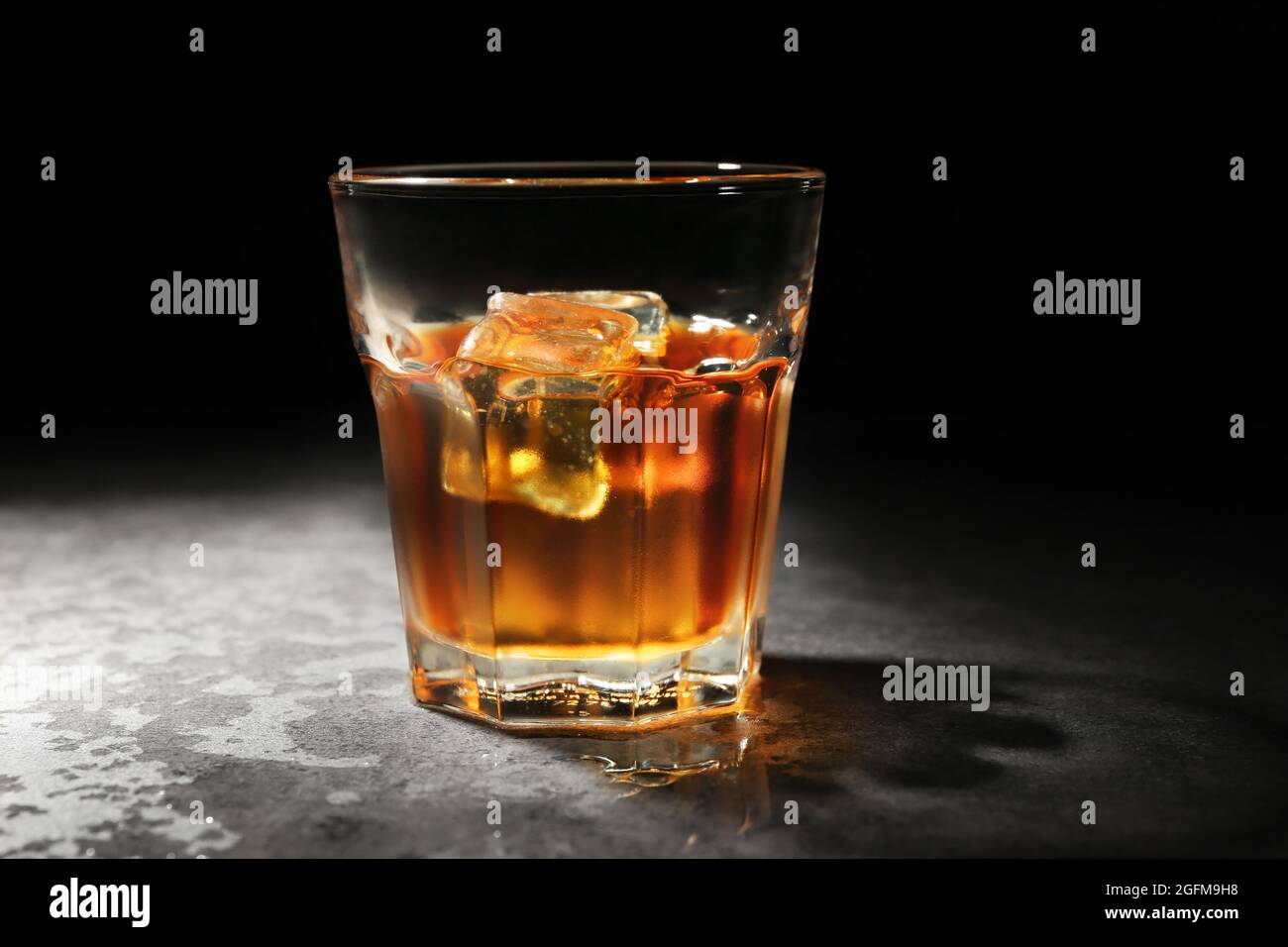 Glass of whisky on grey textured table closeup Stock Photo - Alamy