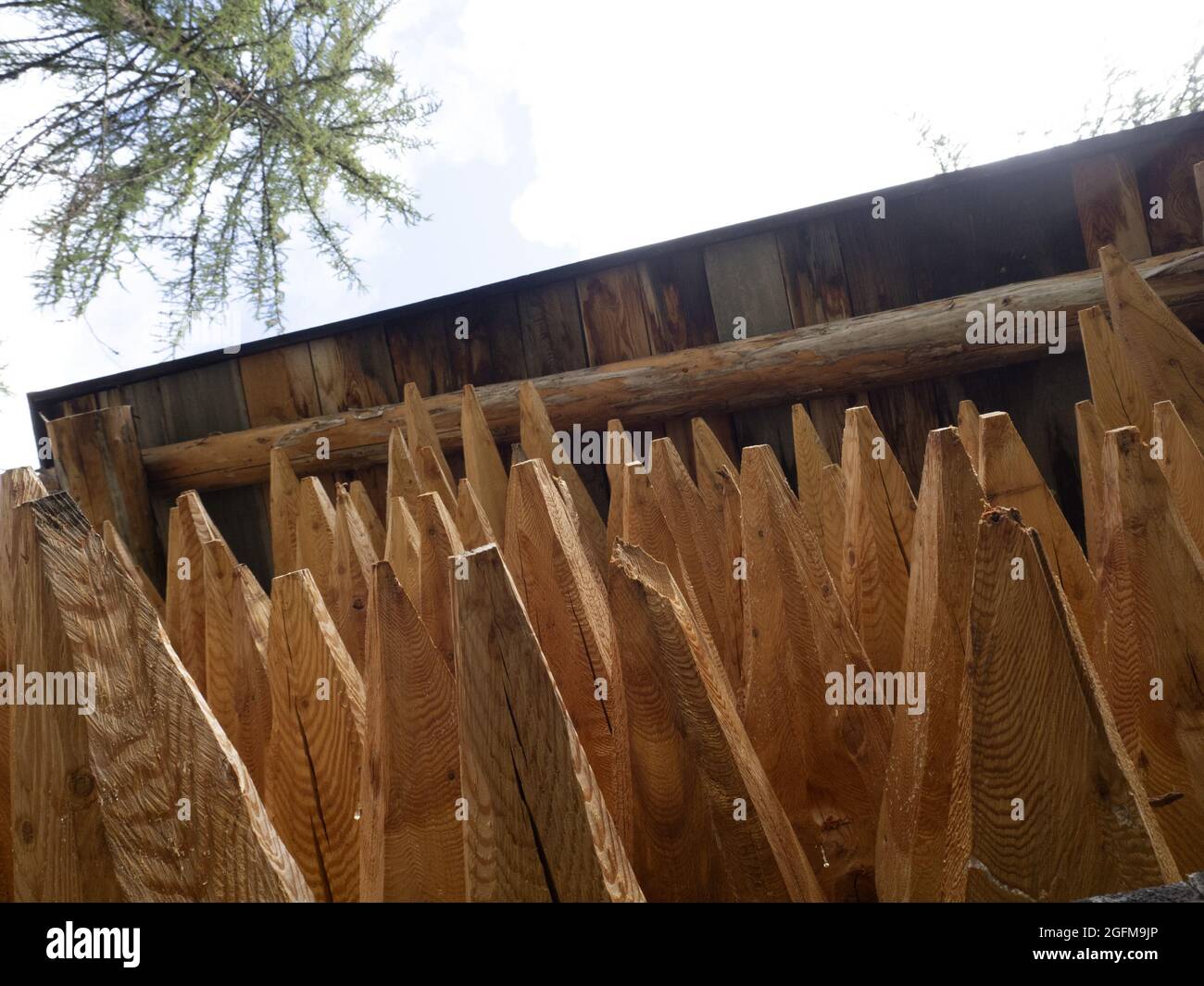 Pointed wood logs pattern inside hut Stock Photo - Alamy