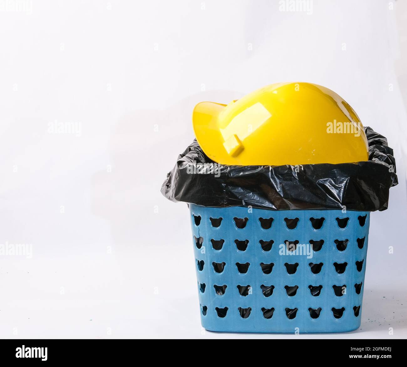 Photo of engineer helmet in a plastic trash bin Stock Photo - Alamy