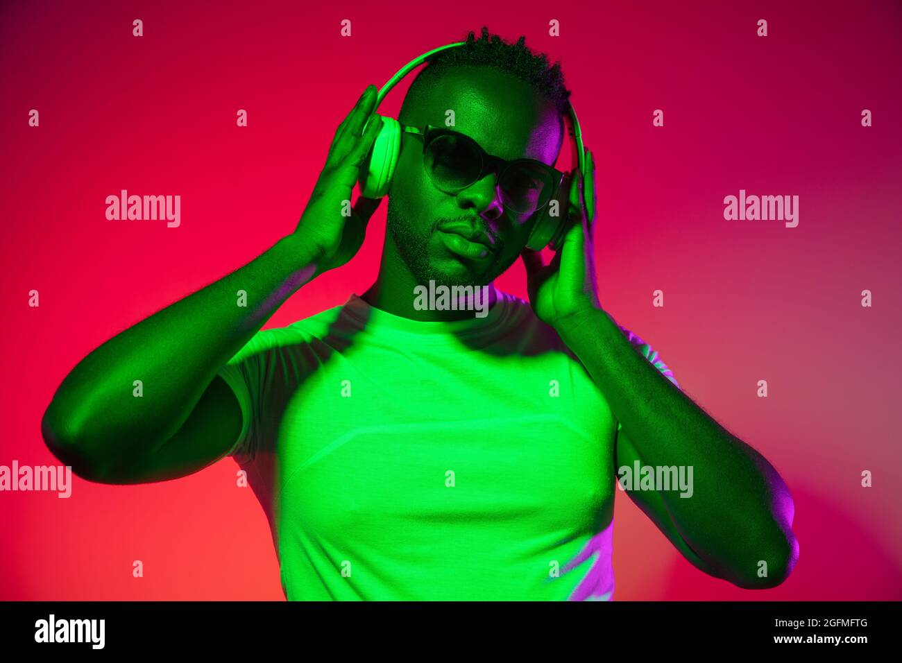 Creative image of African young man in casual clothes isolated on red ...