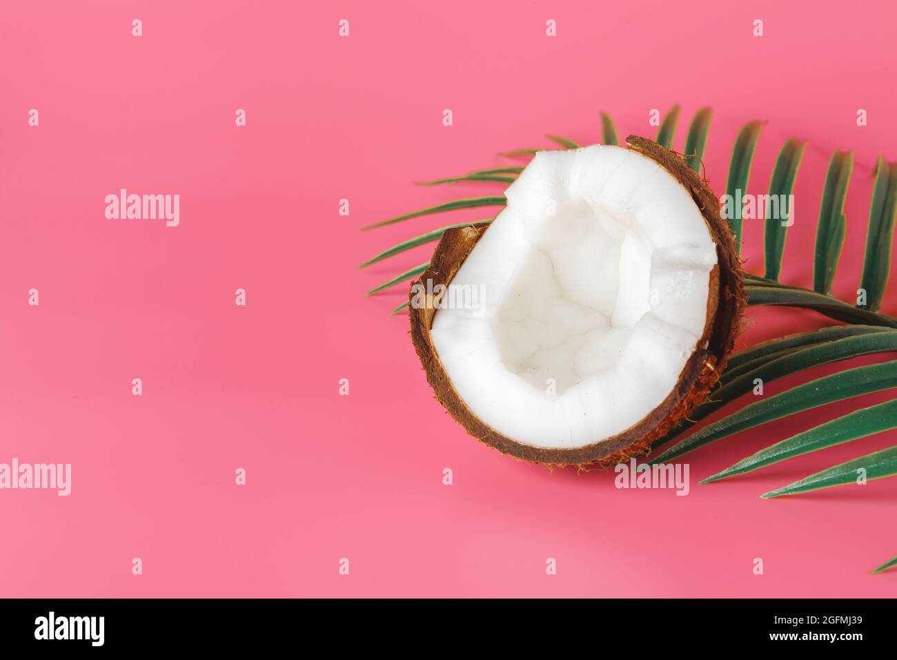 Coconut halves on a bright pink background Stock Photo - Alamy