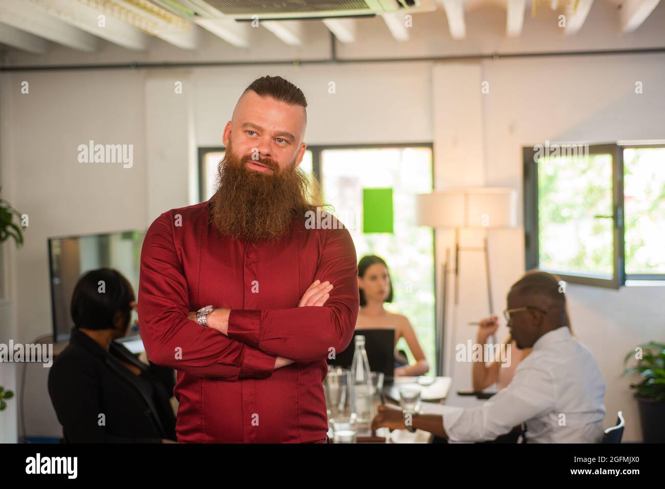 Bearded businessman is posing in front of his group of coworkers Stock ...
