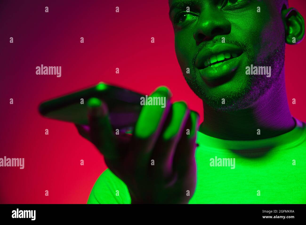 Creative image of African young man in casual clothes isolated on red ...