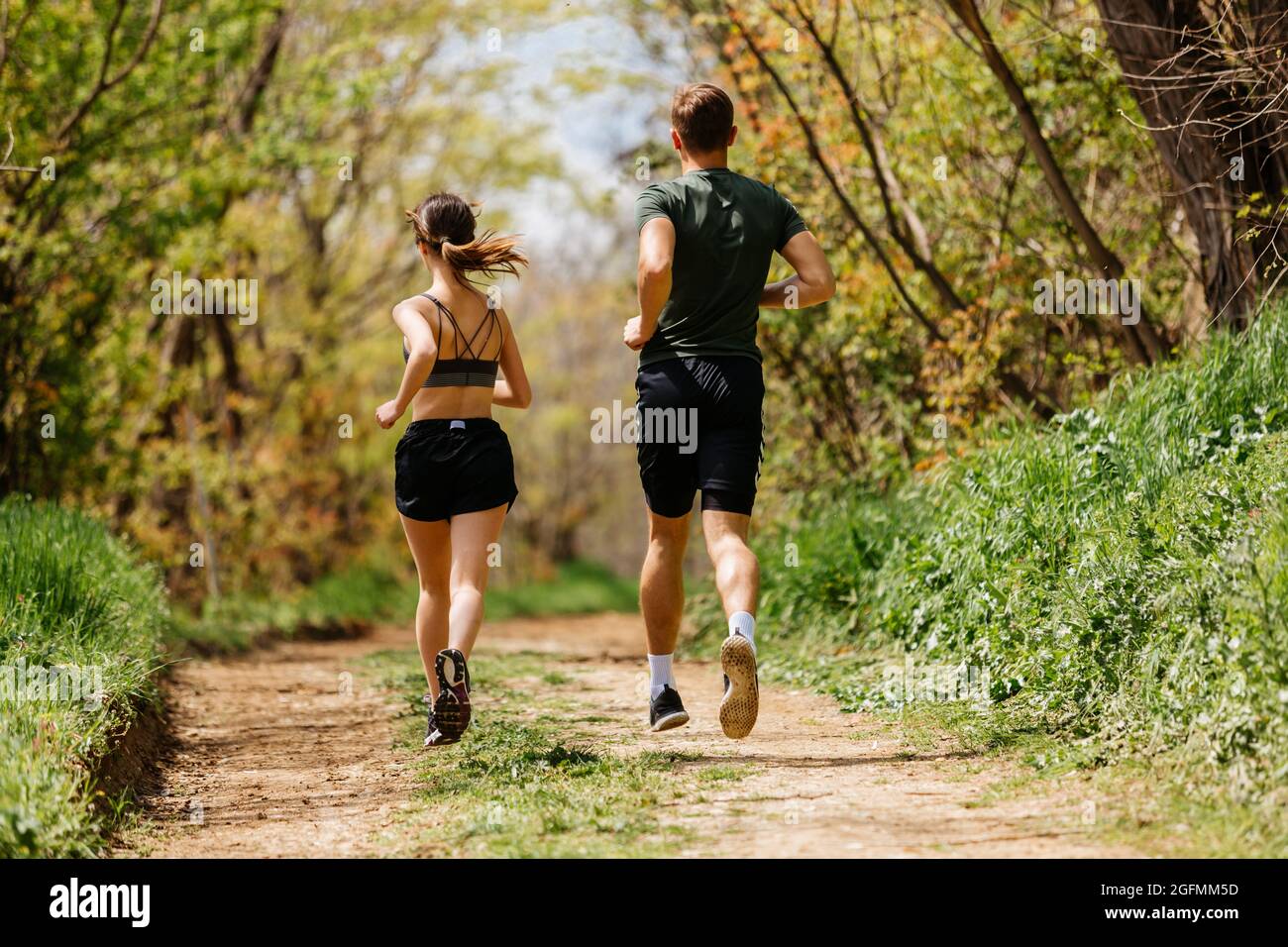 Sport people running in park together. Young couple jogging at outdoor ...