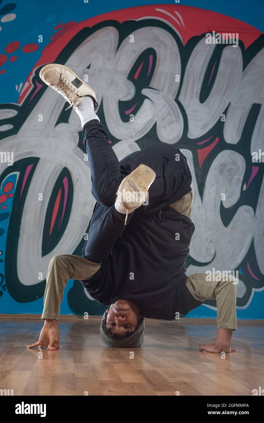 Modern rapper dancing in garage. Urban lifestyle, hip hop Stock Photo ...