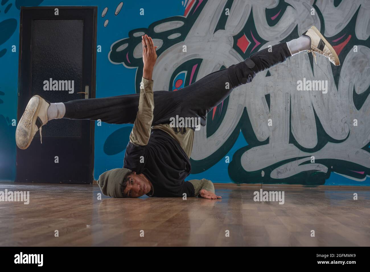 Modern rapper dancing in garage. Urban lifestyle, hip hop Stock Photo ...