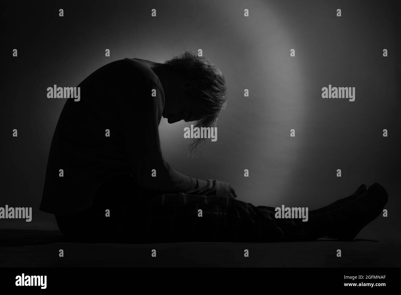 Boy sitting head down sad Black and White Stock Photos & Images - Alamy