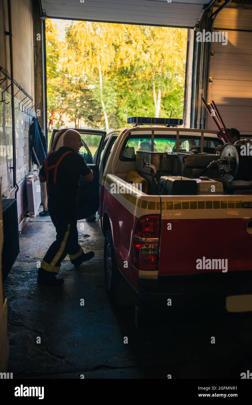 Fire engine truck parked inside the garage of the fire department Stock ...