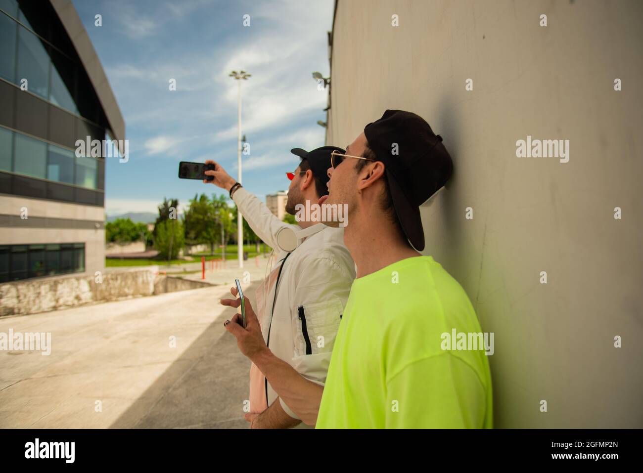 Two male friends are talking selfie whiel hanging out together Stock ...