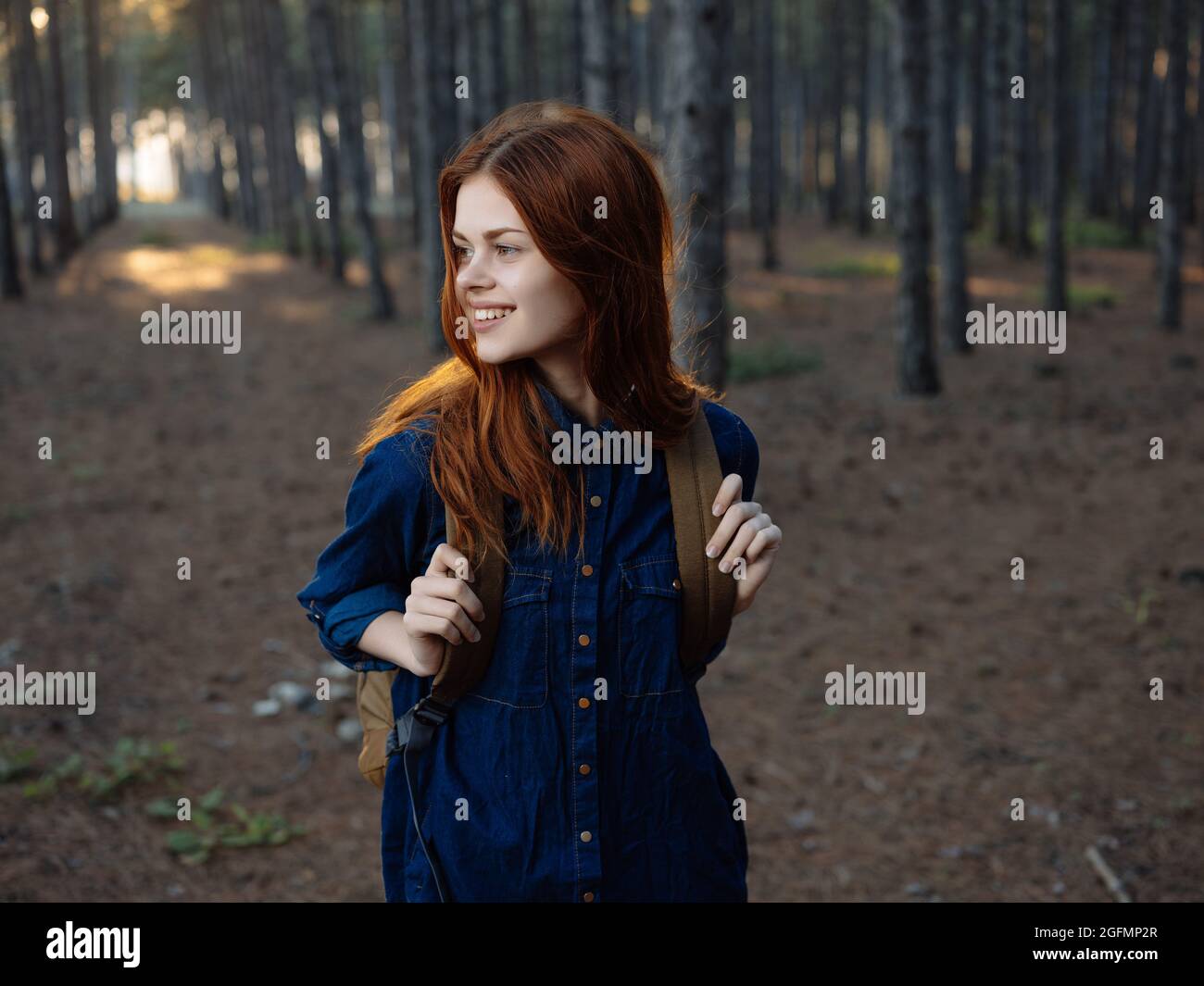 pretty woman in the forest with a backpack nature walk Stock Photo - Alamy