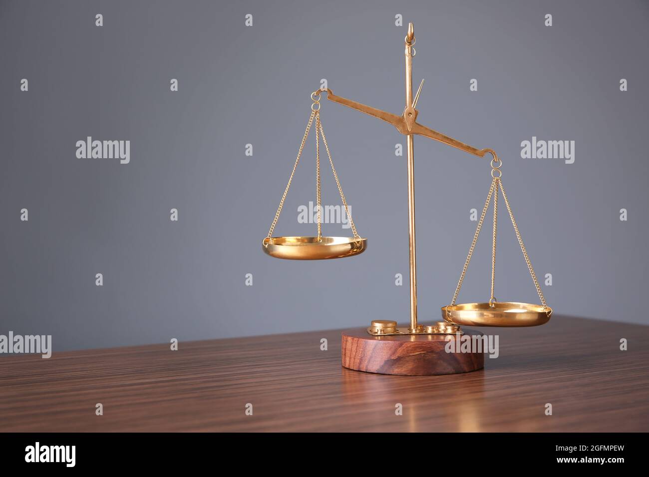 Justice scales on wooden table and grey background Stock Photo - Alamy
