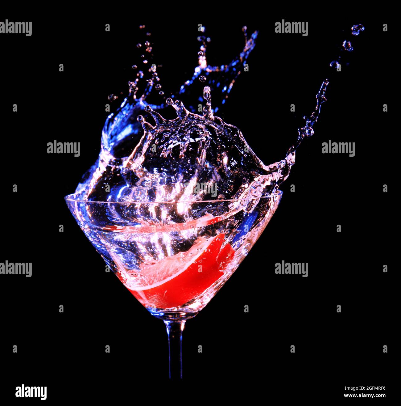 Colorful cocktail with splash on dark background Stock Photo - Alamy