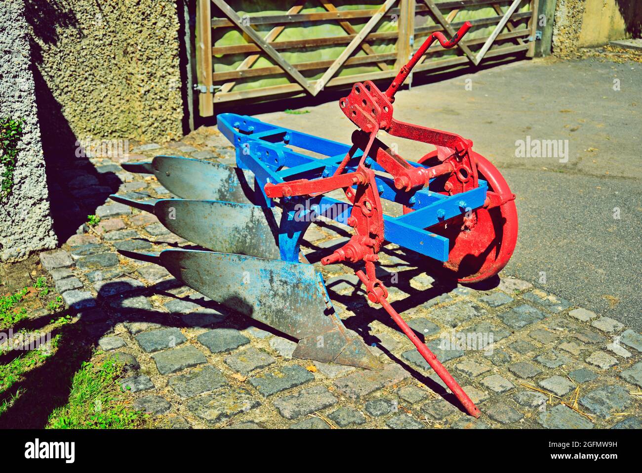 Refurbished farmer's plough on display Stock Photo - Alamy