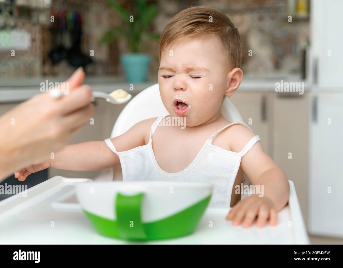 Charming little baby boy 8-11 months doesn't want to eat porridge from ...