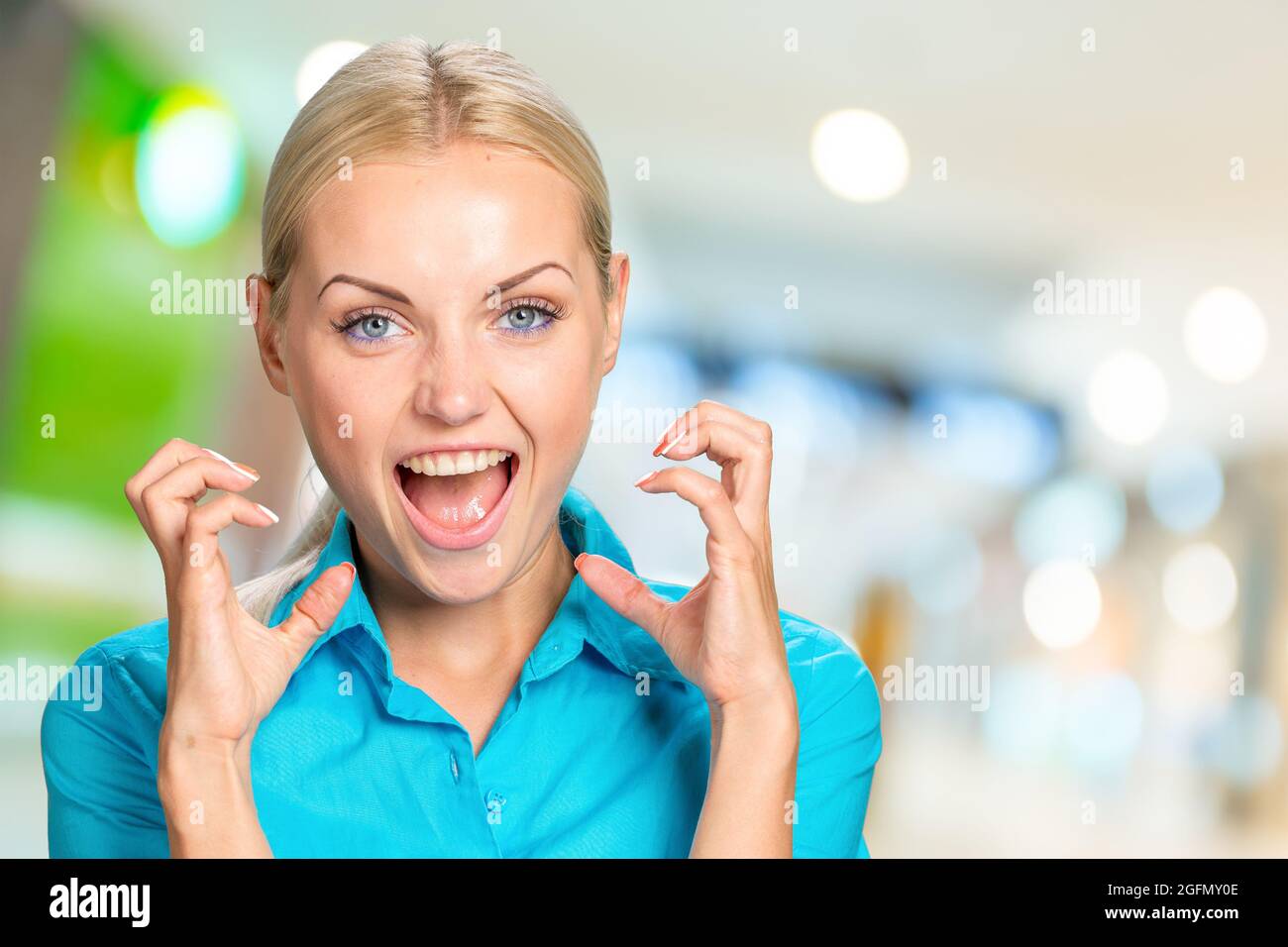 Picture of angry young woman standing isolated Stock Photo - Alamy