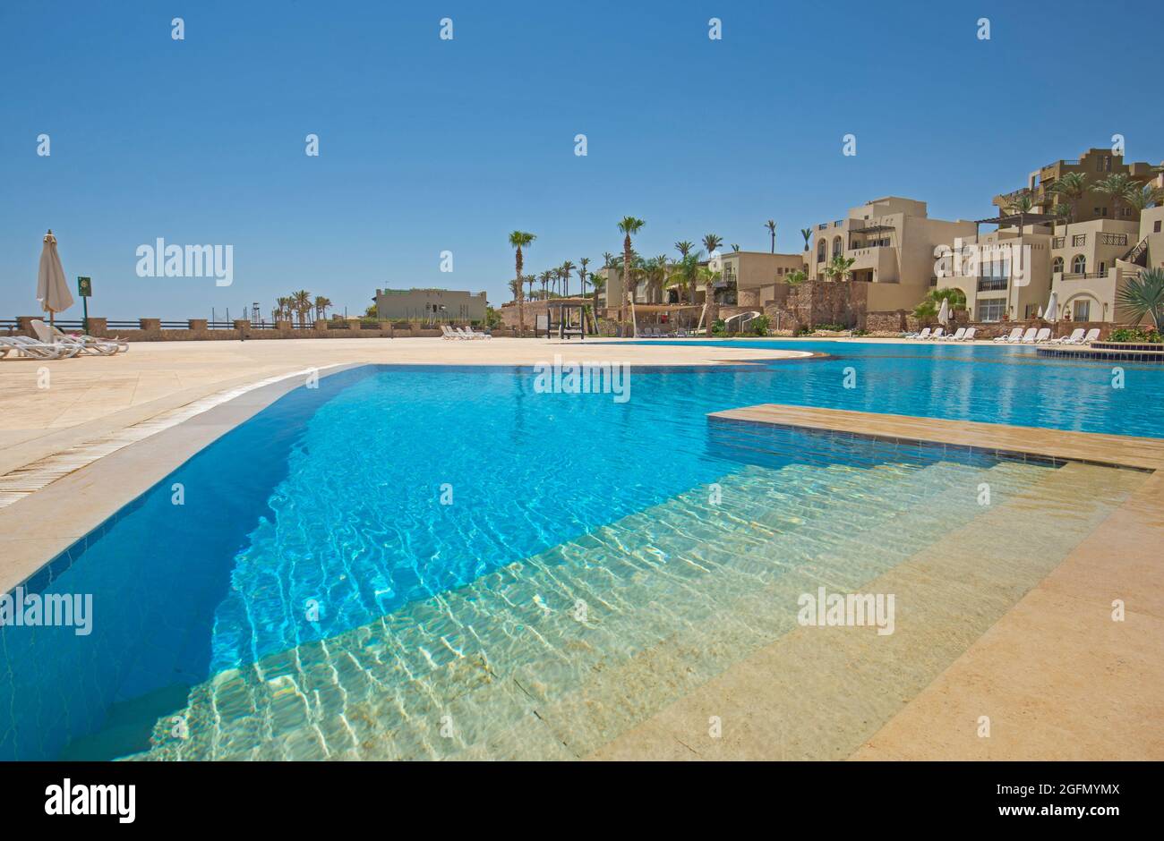 Large outdoor swimming pool at a luxury tropical hotel resort with ...