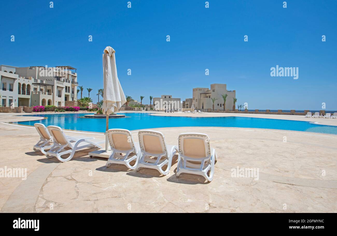 Large outdoor swimming pool at a luxury tropical hotel resort with sun ...