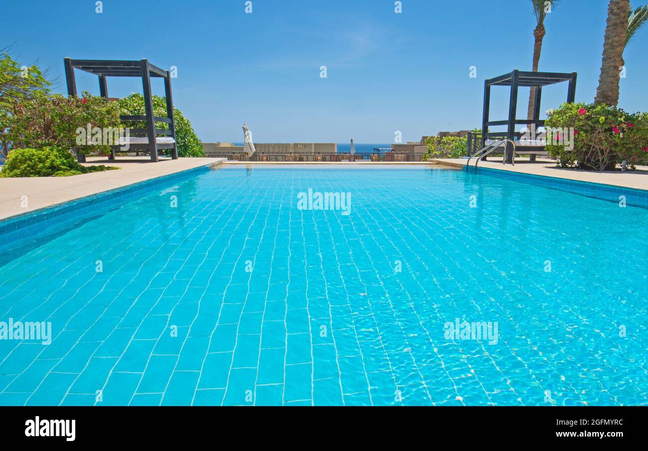 Large outdoor infinity swimming pool at a luxury tropical hotel resort ...