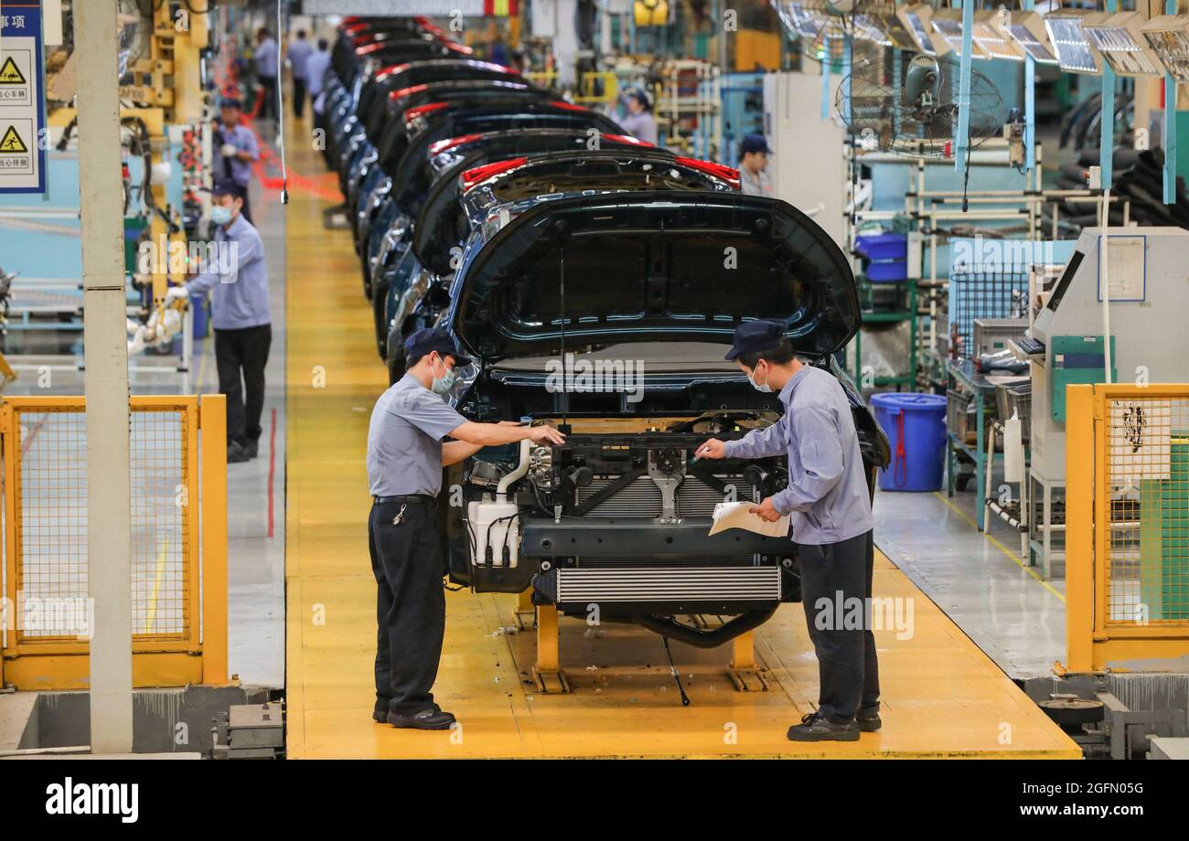 Workers assemble cars produced at a factory of Haima Automobile in ...